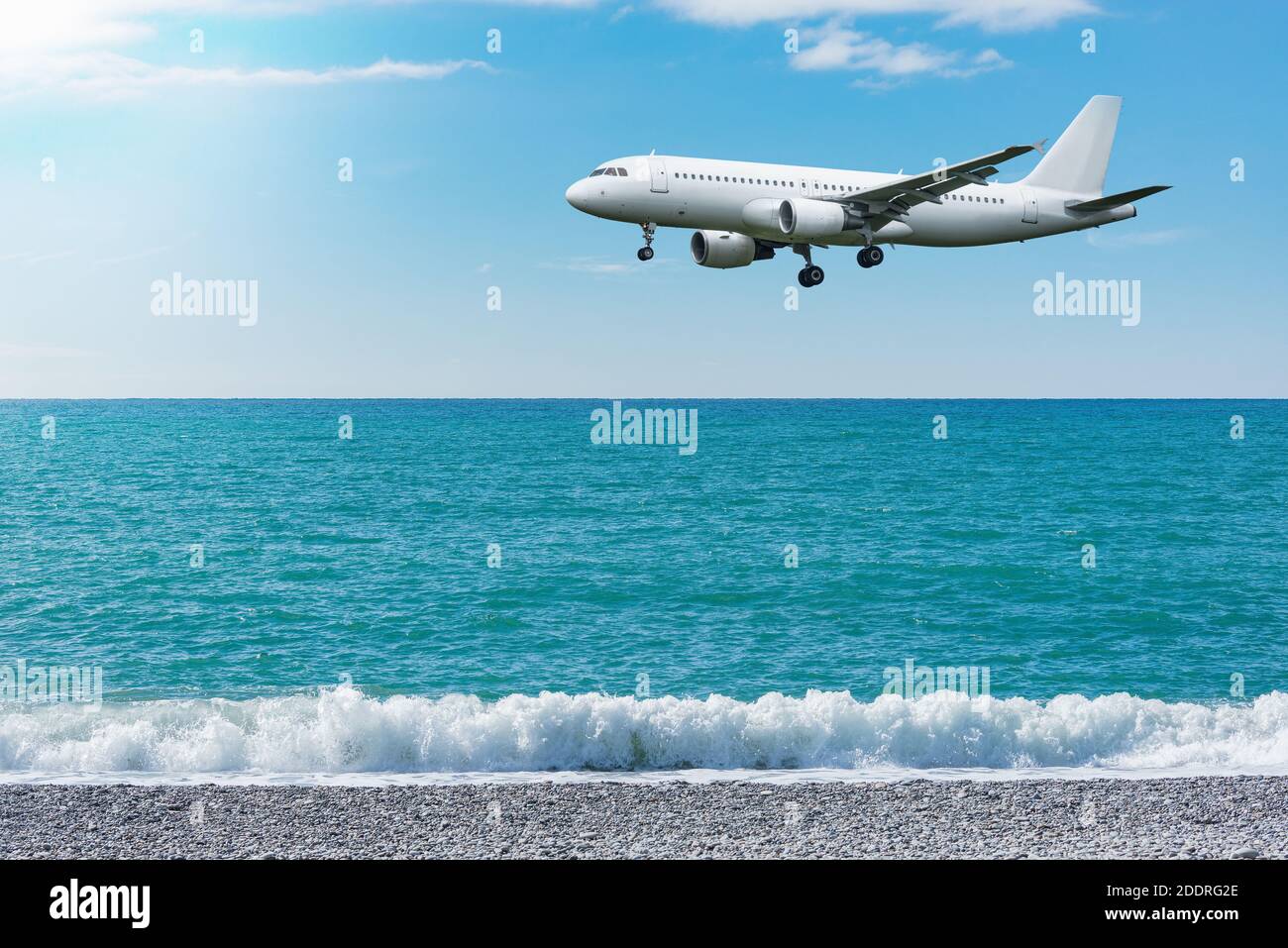 Flight of the plane above the ocean before landing at day time Stock ...