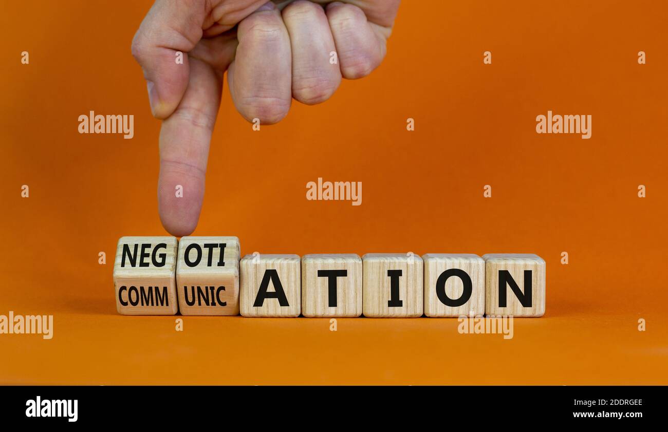 Negotiation and communication. Hand turns cubes and changes the word ...