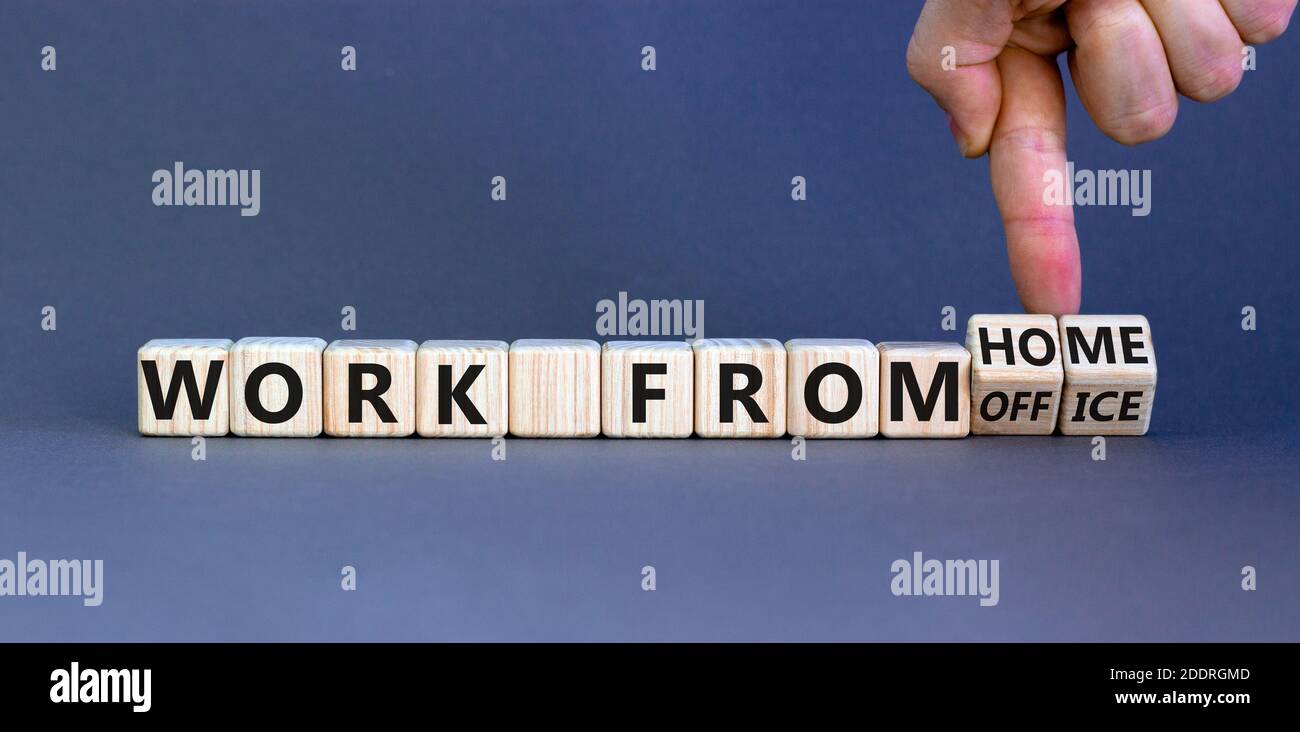 Work from home. Hand turns cubes and changes words 'work from office ...