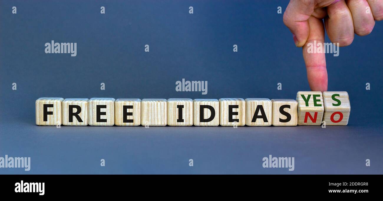 Time to free ideas. Male hand flips wooden cubes and changes words ...
