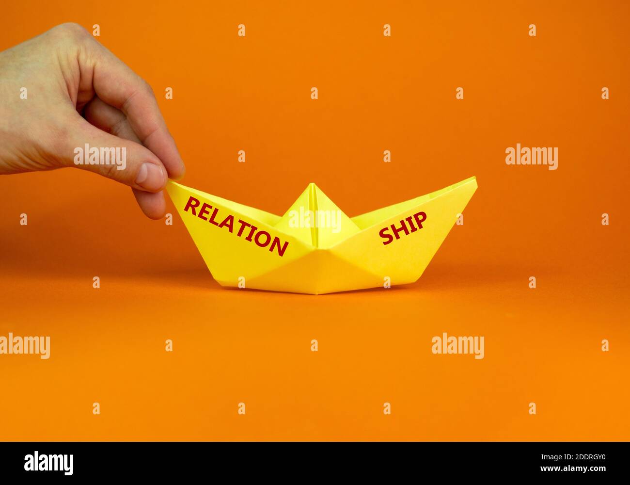 Image of businessman pushing paper made origami boat forward in a ...