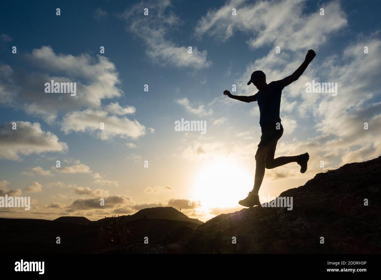 Jogger, runner, running downhill at sunrise Stock Photo - Alamy