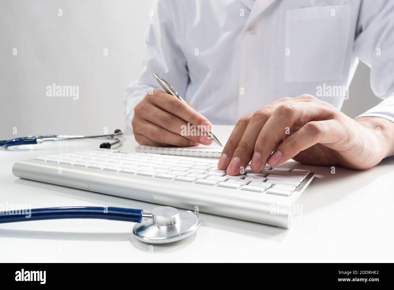Doctor typing on wireless computer keyboard Stock Photo - Alamy
