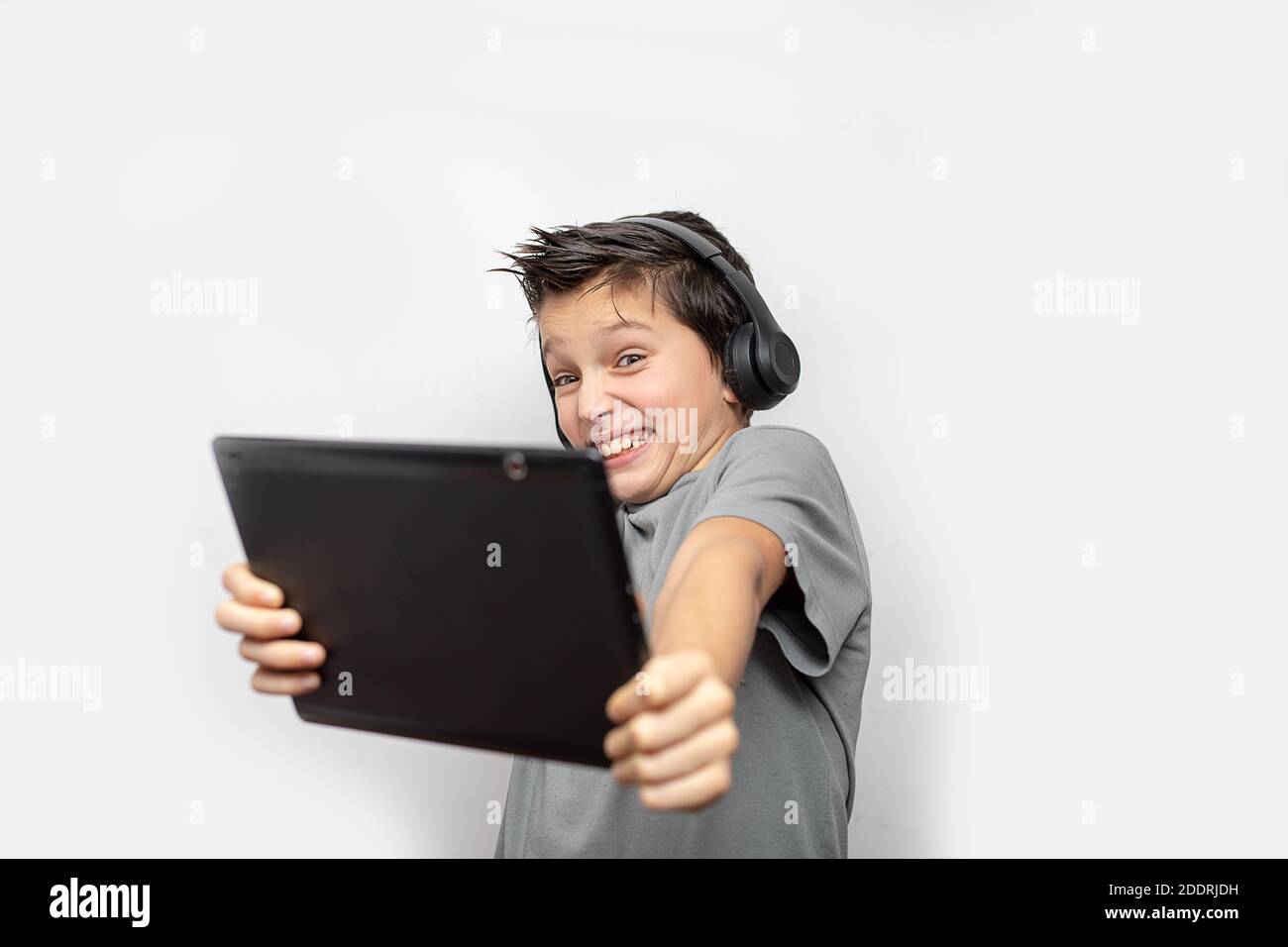 Shocked kid school teenage boy with digital tablet. Shouting and ...
