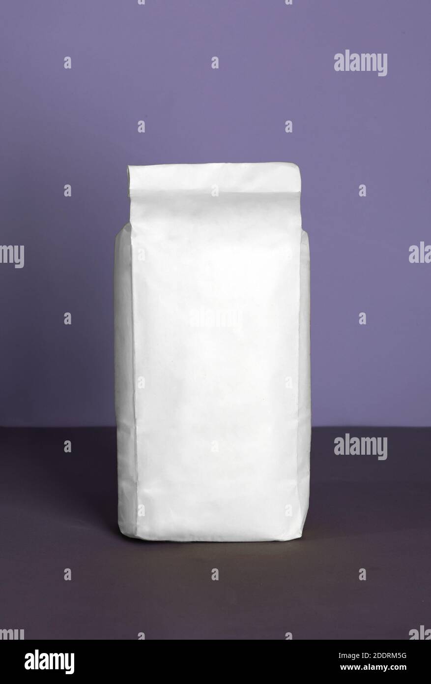 Small blank bulky white package with product on a purple-lilac ...
