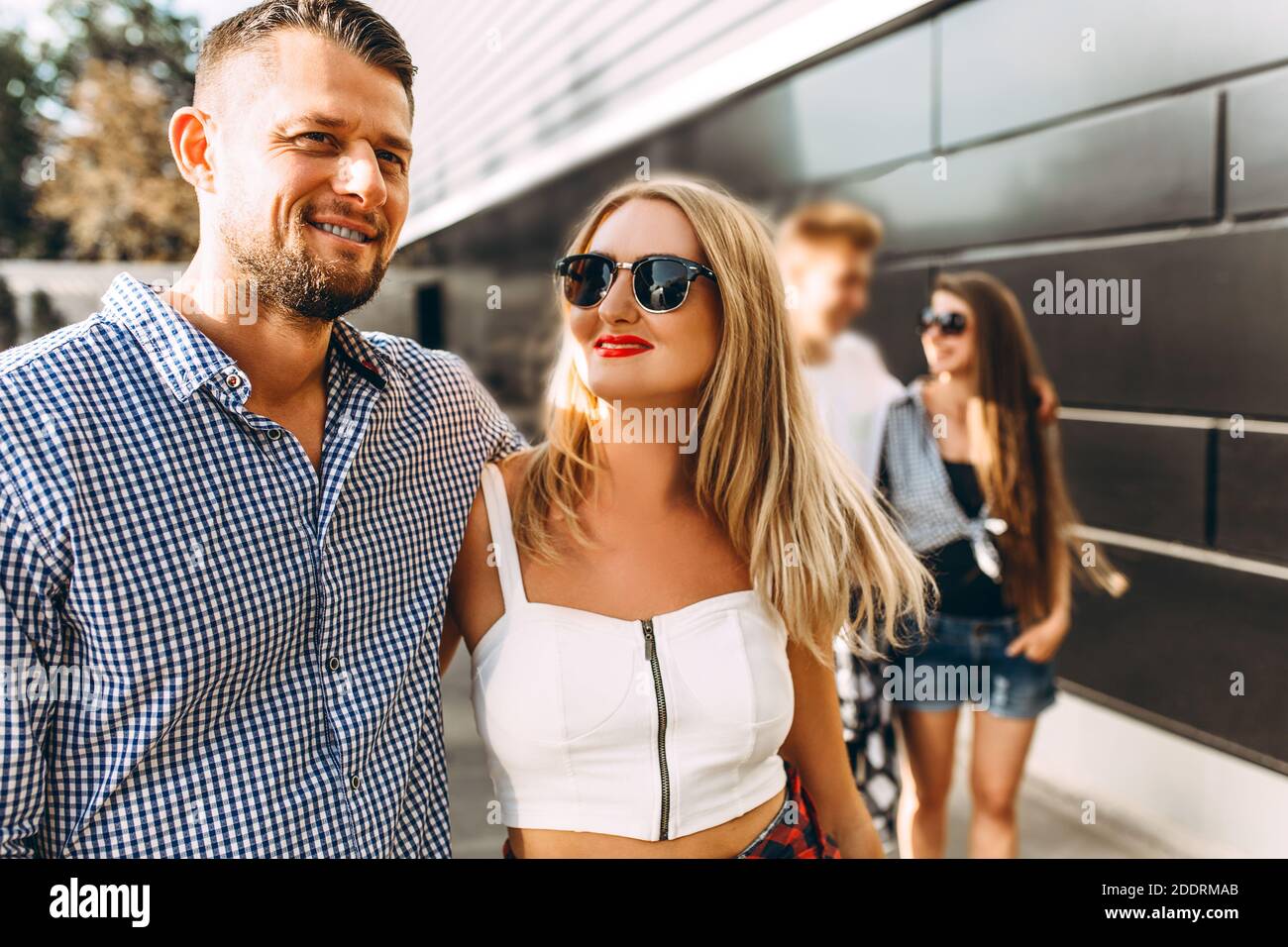 A group of young friends, girls and guys walking together in the fresh ...