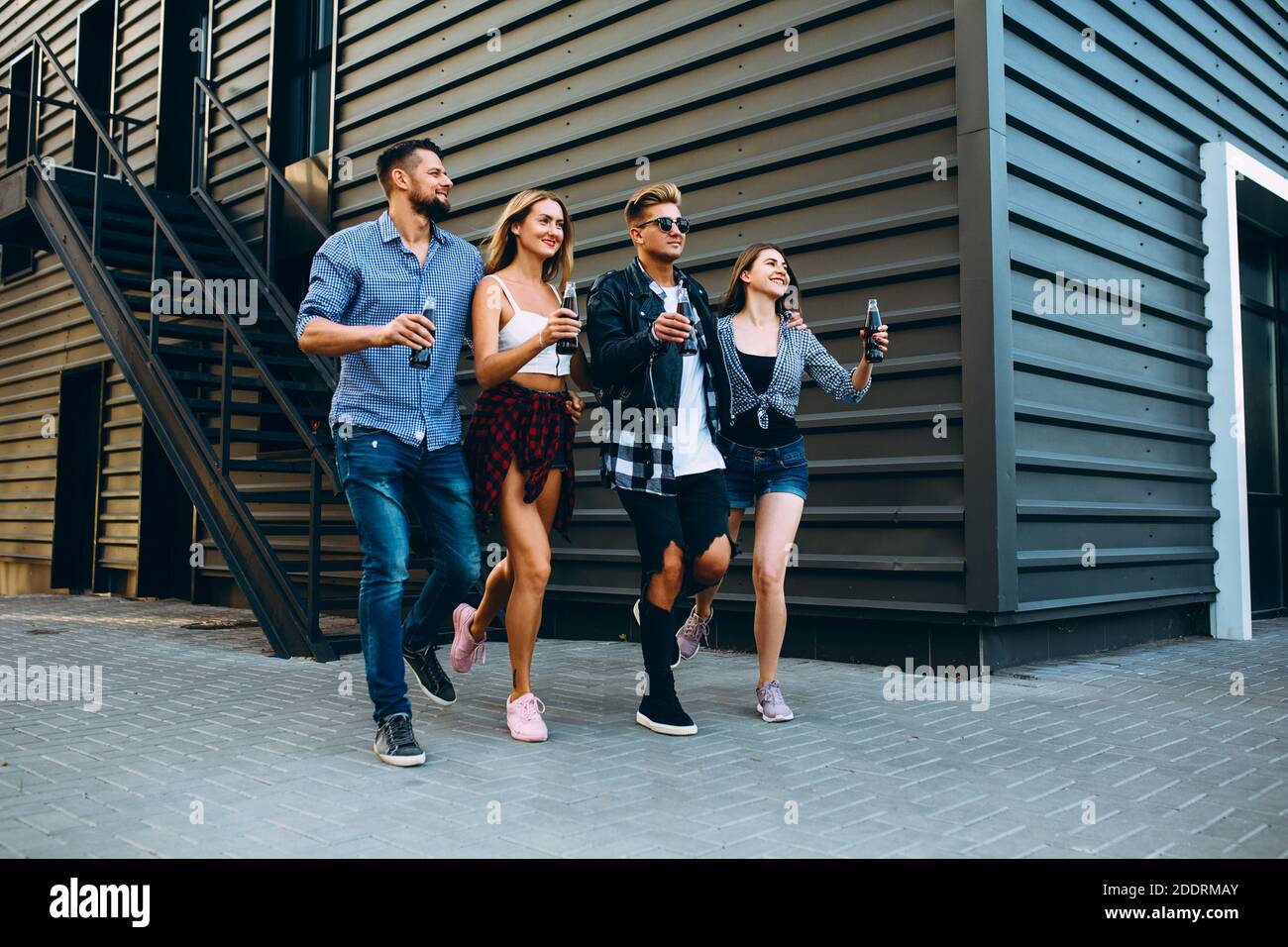 A group of young friends, girls and guys walking together in the fresh ...