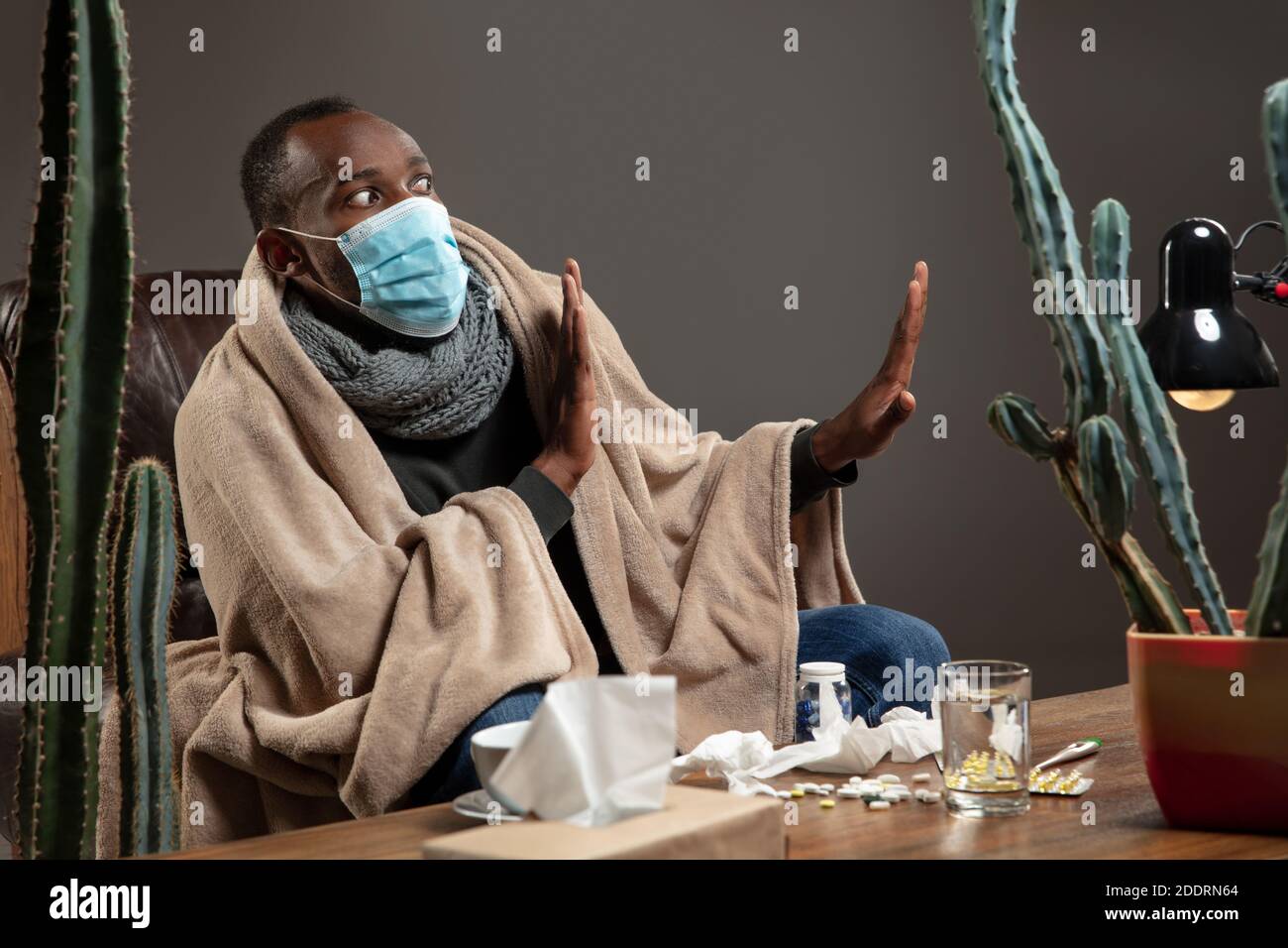 Man wrapped in a plaid wearing face mask trying to protect himself from ...
