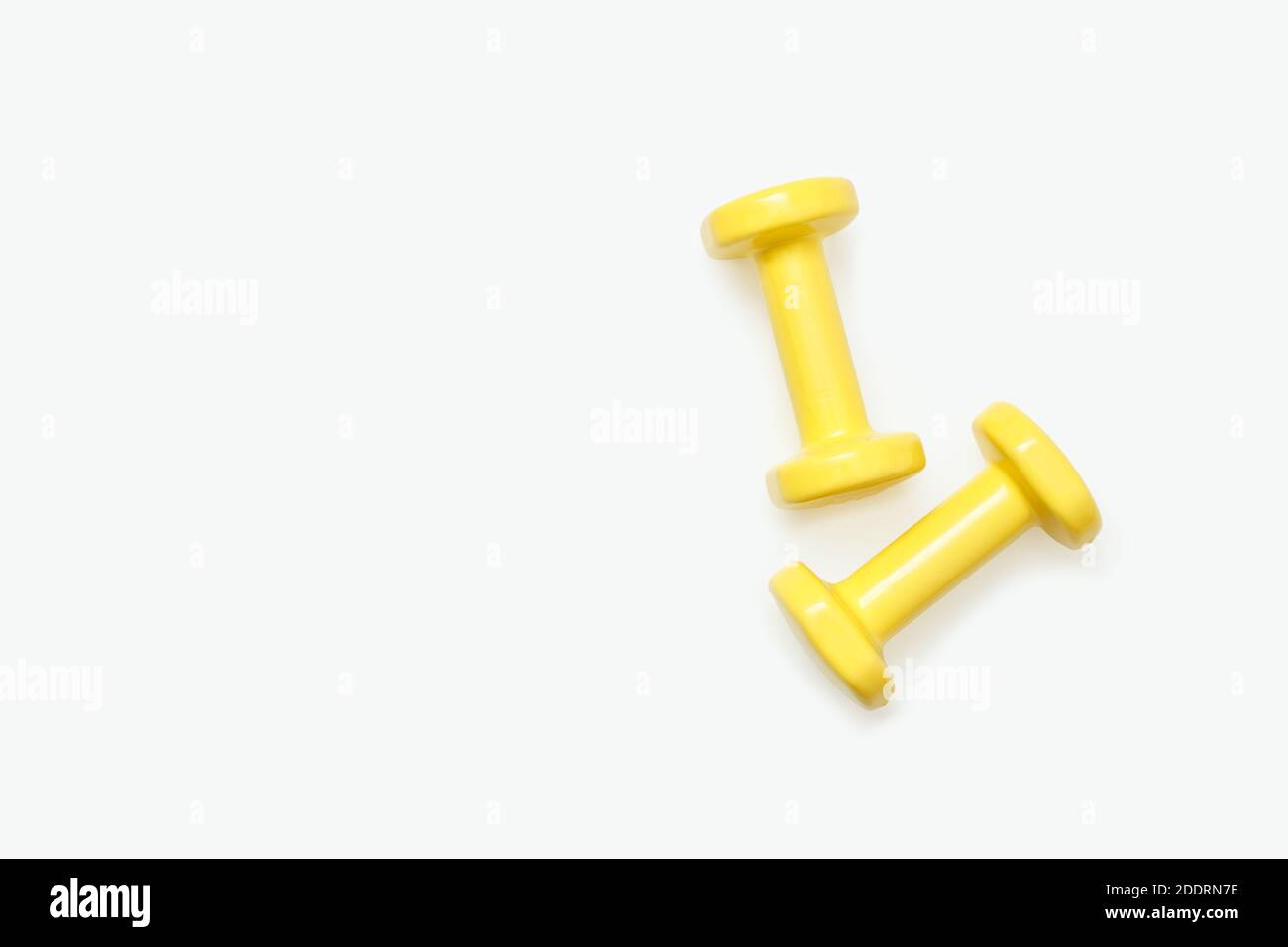Yellow dumbbells isolated on white background. View from above Stock ...