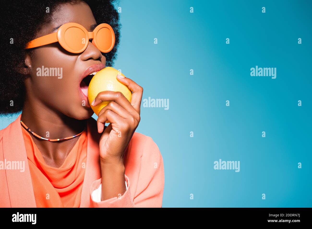 Girl biting lemon hi-res stock photography and images - Alamy