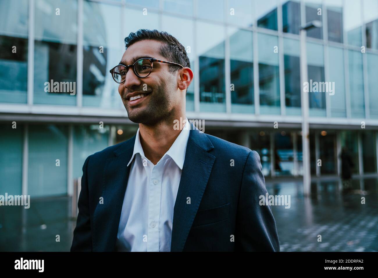 Portrait businessman smiling standing outside banking office before ...