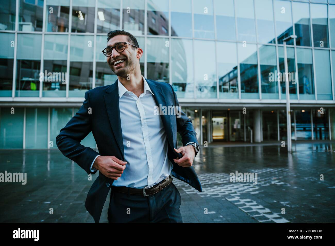Caucasian businessman laughing standing outside banking office before ...