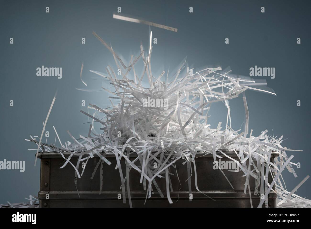 Shredded paper stripes seem to explode in a box and expand their volume ...
