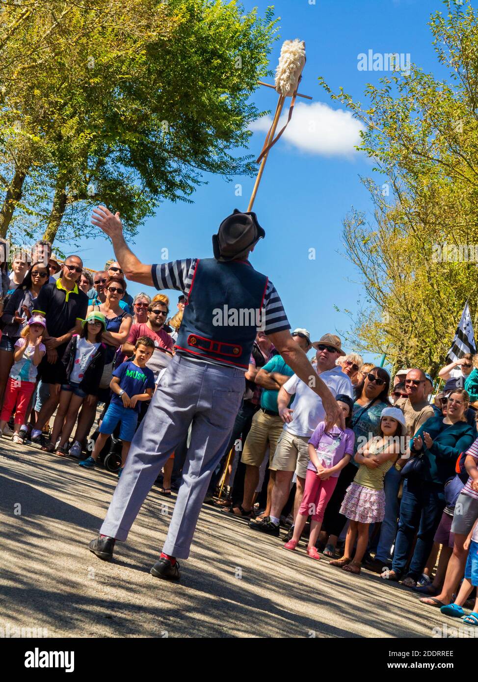 Traditional clown performing outside to a village crowd in Plovan in ...