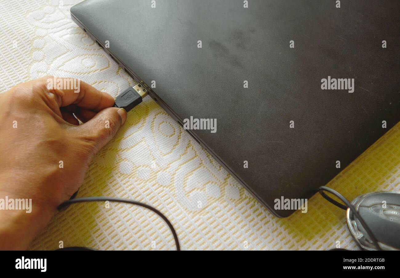 Human Hand Connecting Computer Mouse Connection Cable Plug In The Laptop Keyboard Network