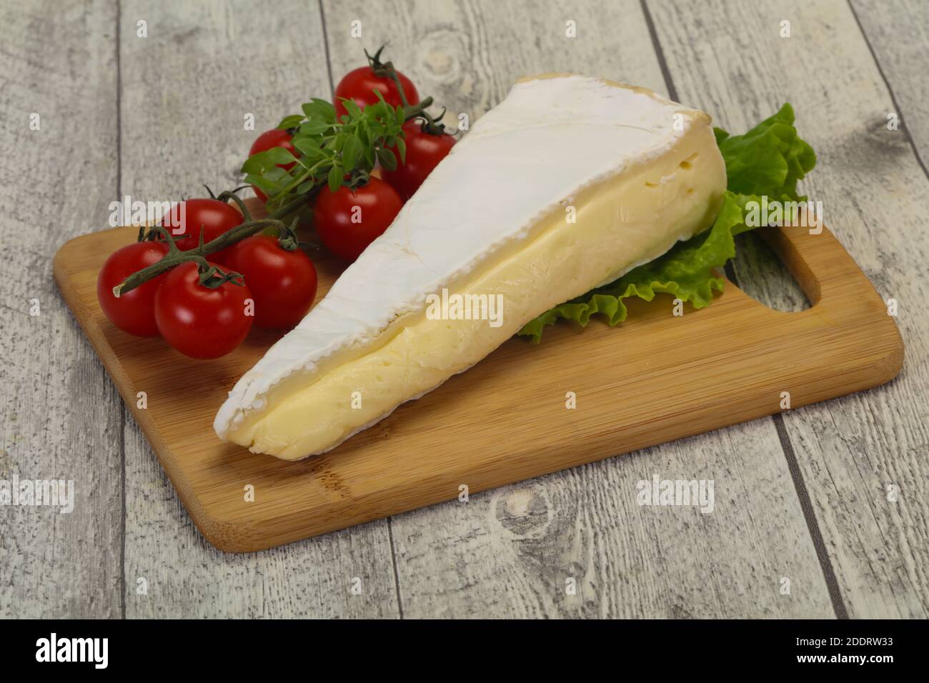 Brie cheese triangle served salad leaves Stock Photo - Alamy