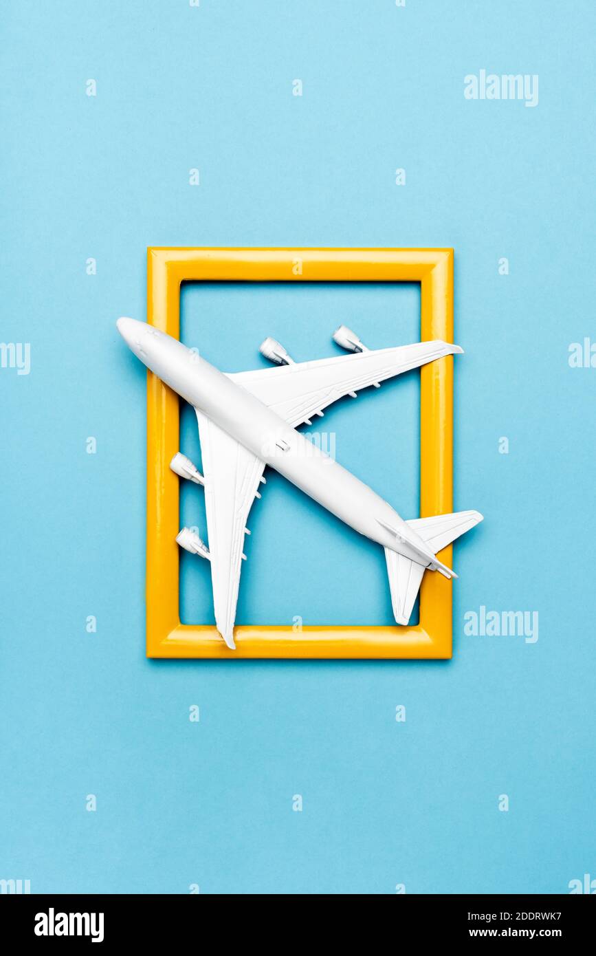 top view of white plane model and empty frame on blue background Stock ...