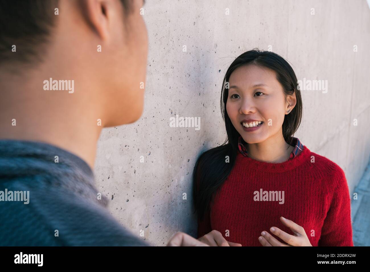 Asian couple having a conversation Stock Photo - Alamy