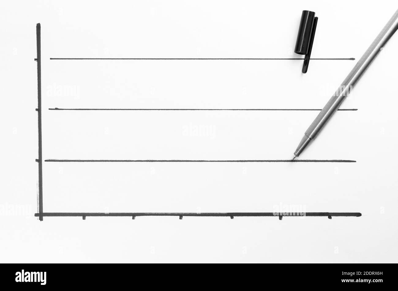 A top view closeup of a graph on a white paper with a pen on it Stock ...