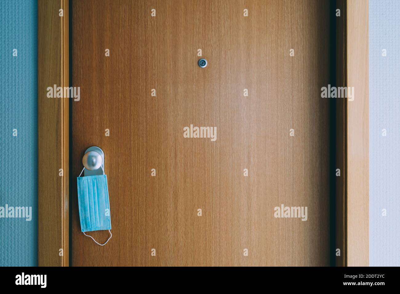 WOODEN DOOR WITH MASK HANGED ON THE LATCH IN A HOUSING PROTECTS YOU ...