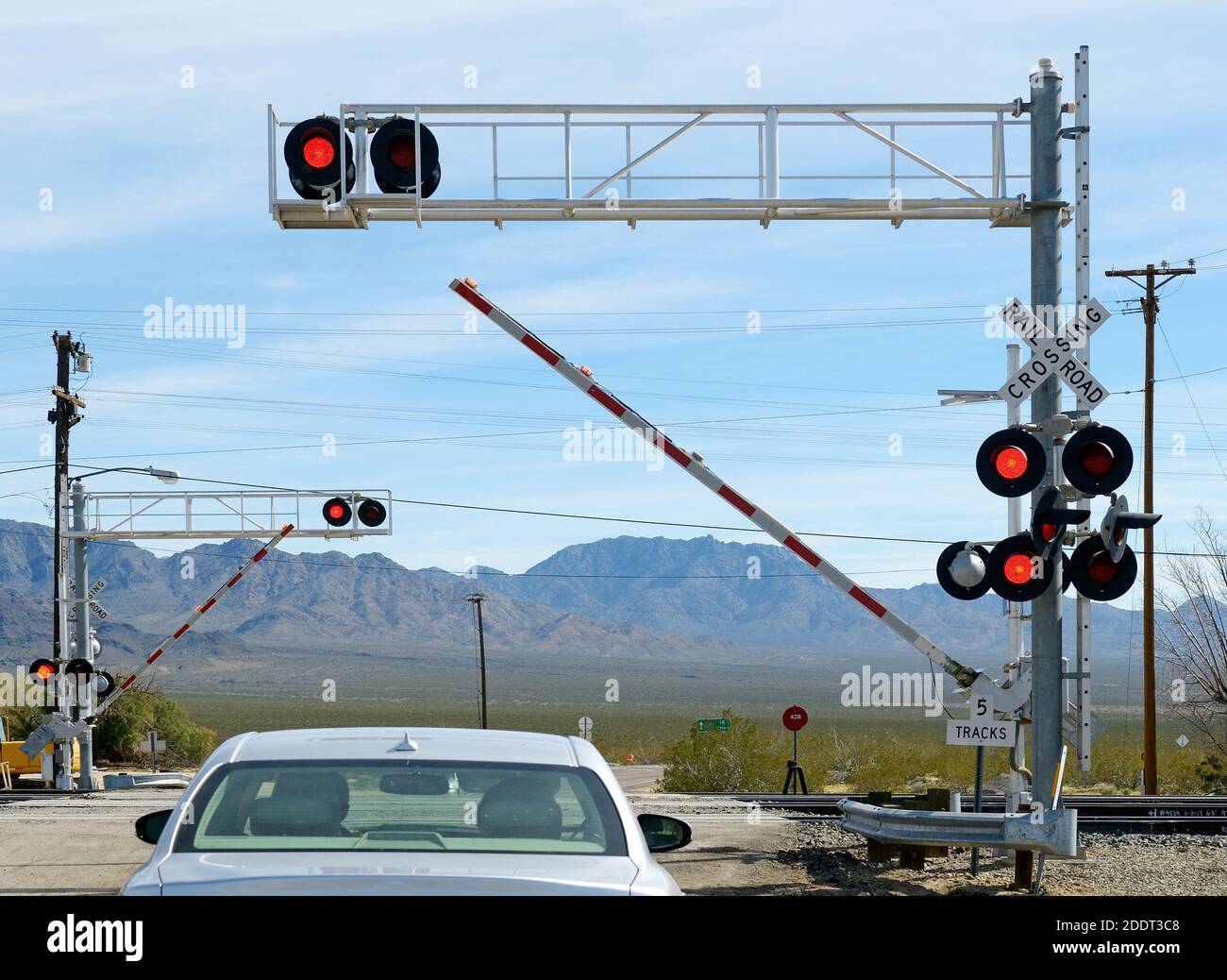 Car waiting at railroad crossing. Opening or closing barrier in the ...