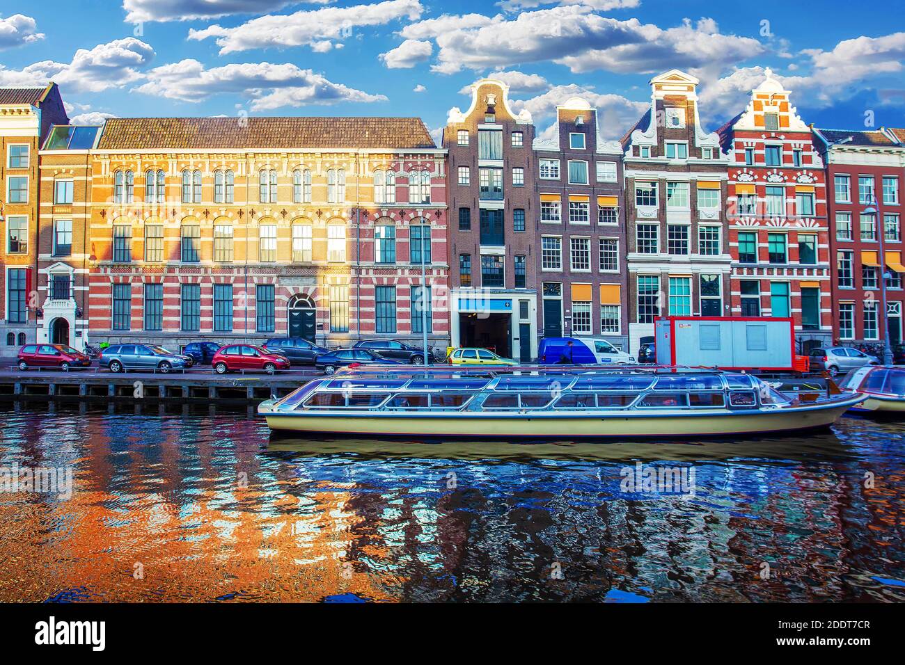 Classic view ofAmsterdam : medieval buildings , canal , boat , and ...