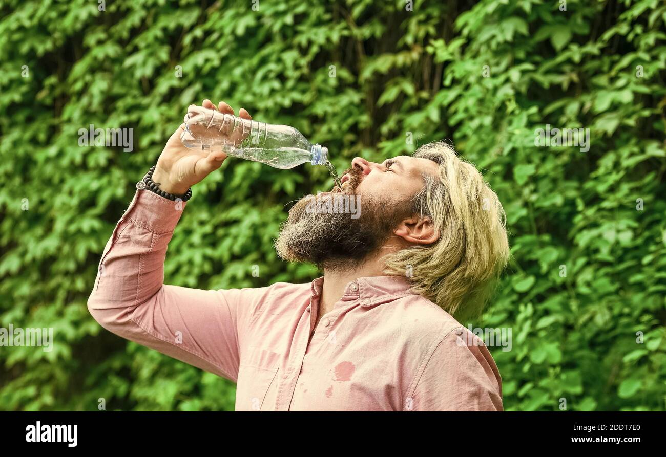 drain the bottle. Daily intake of water. Thirsty male model enjoying ...