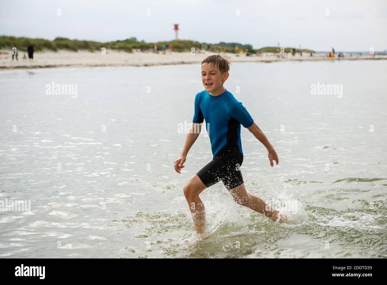 Run into ocean beach wetsuit hi-res stock photography and images - Alamy