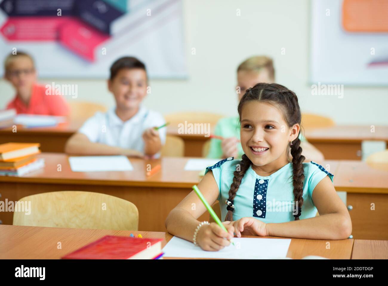 Happy clever children learning in classroom and having fun Stock Photo ...
