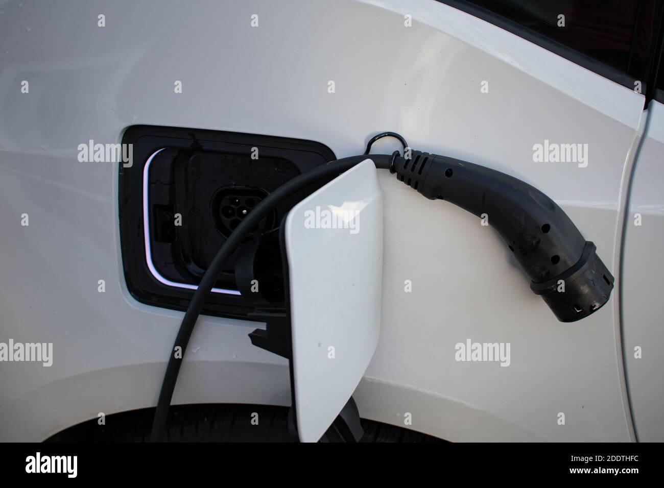 Electric Car Charger At Home - Charging EV with lights on Stock Photo ...