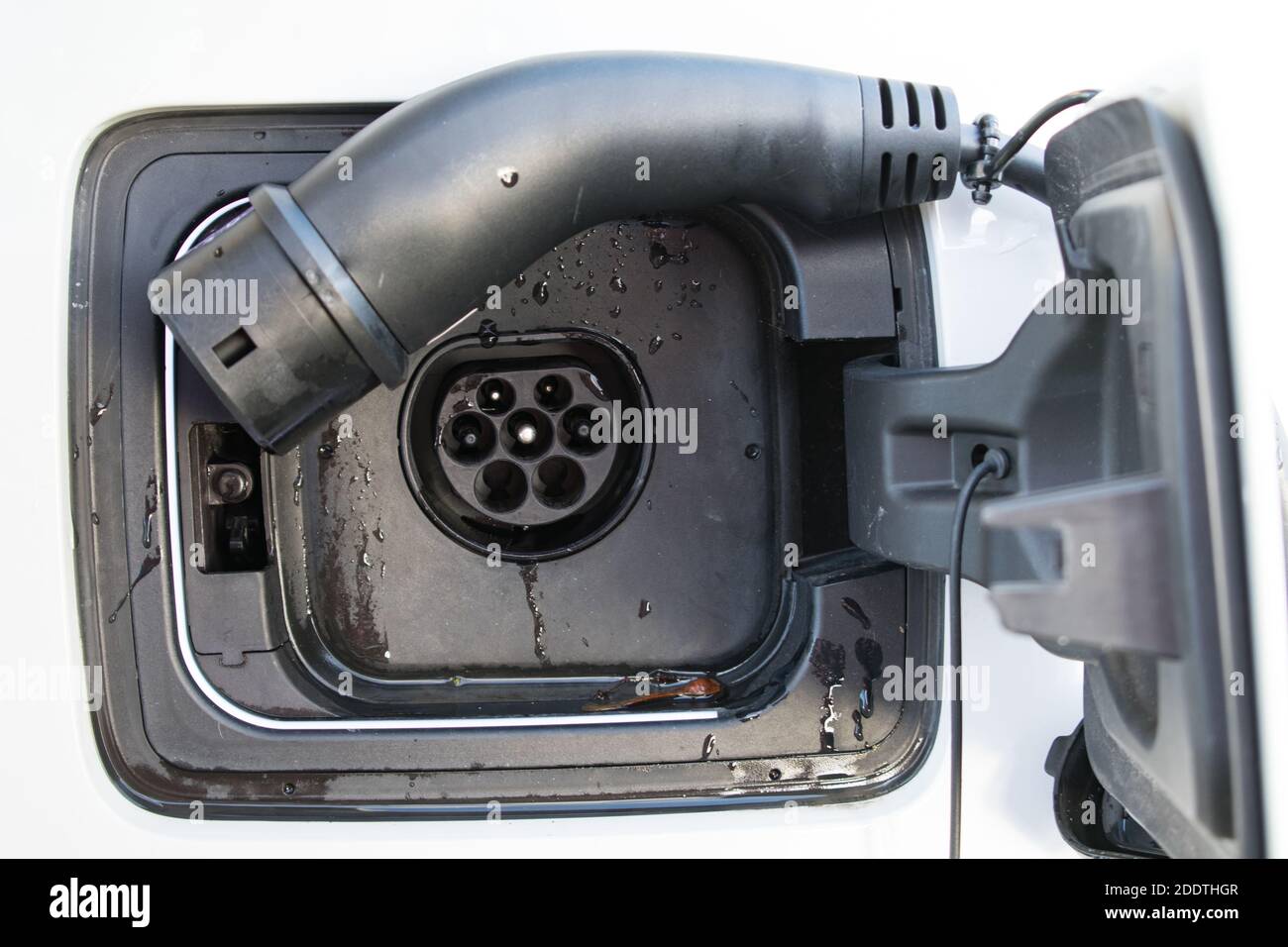 Electric Car Charger At Home - Charging EV with lights on Stock Photo ...