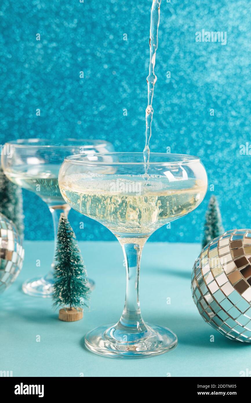 Christmas minimal festive background with disco ball, toy tree, glasses ...