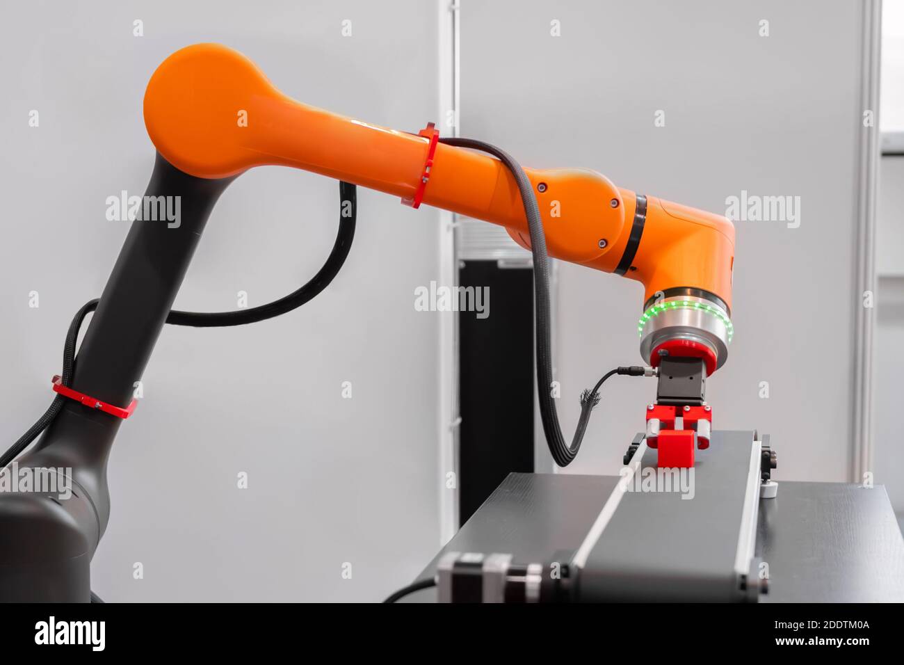 Pick and place robotic arm manipulator moving red toy blocks at robot exhibition Stock Photo - Alamy