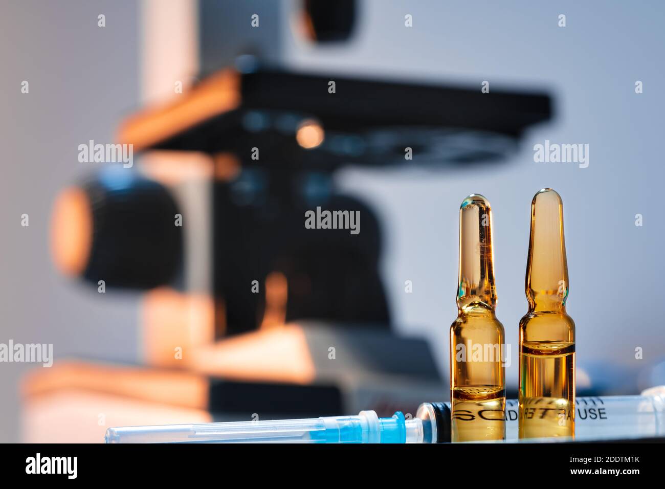 Medical vial with medication near microscope photo Stock Photo - Alamy