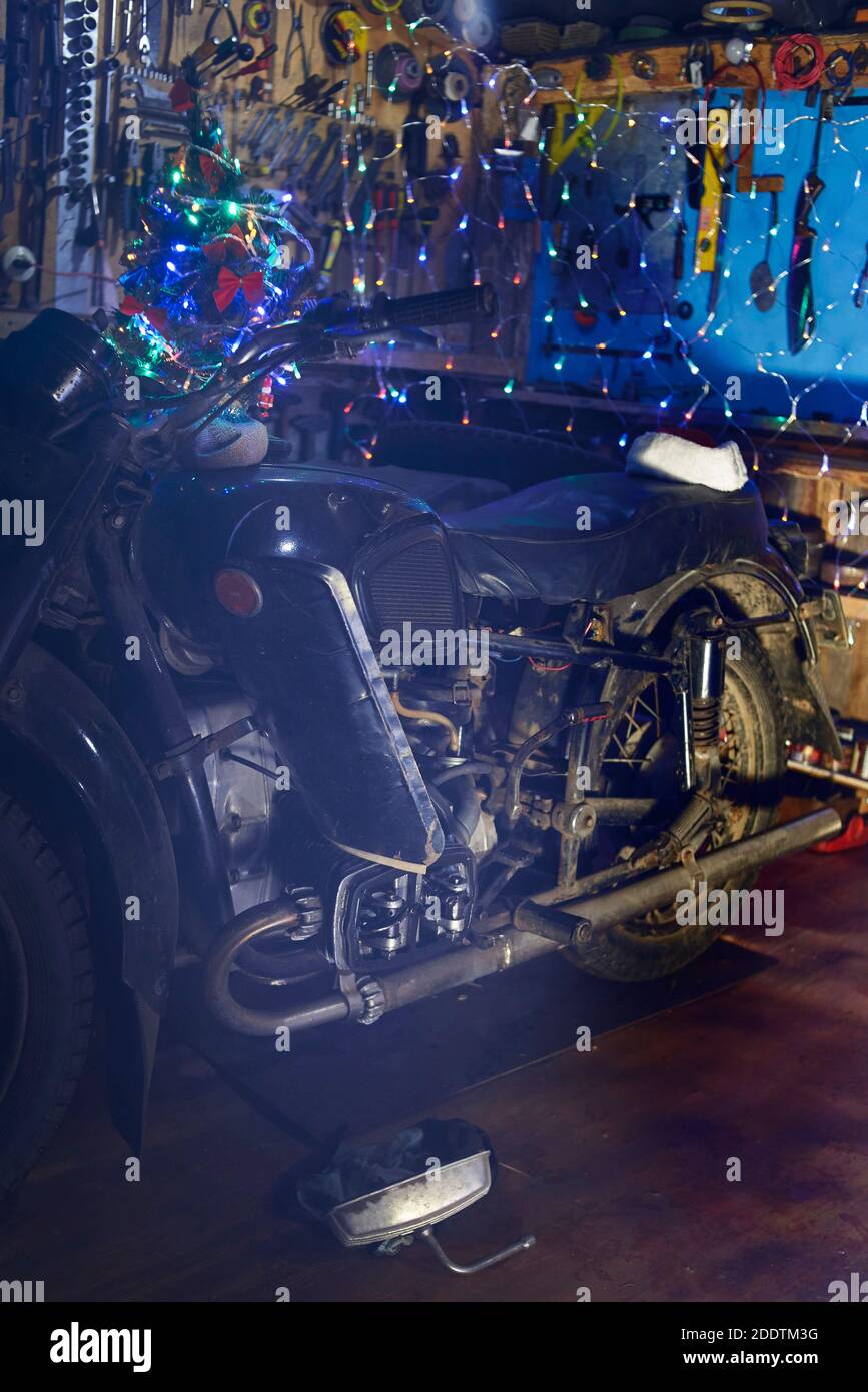 Classic old motorcycle with a Christmas tree in the garage Stock Photo ...