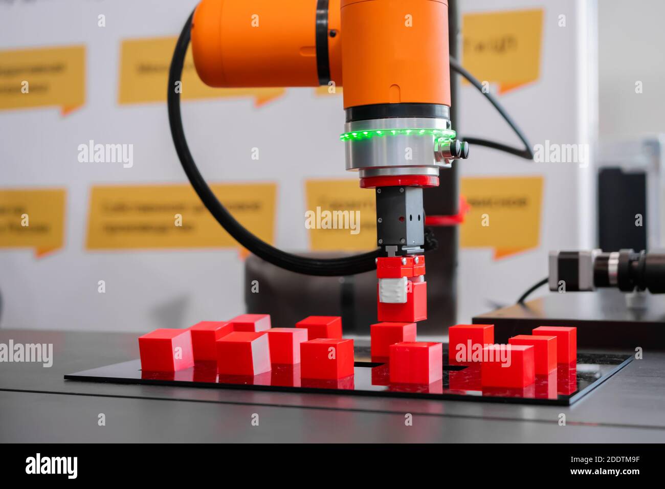 Pick and place robotic arm manipulator moving red toy blocks at robot exhibition Stock Photo - Alamy