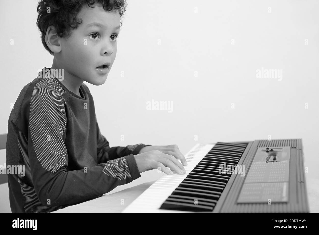 Black boy play piano hi-res stock photography and images - Alamy
