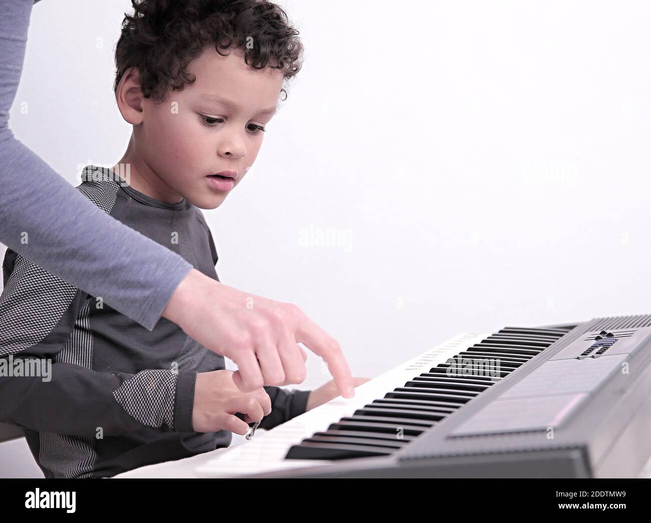 boy playing the piano keyboard on white background stock photo Stock ...