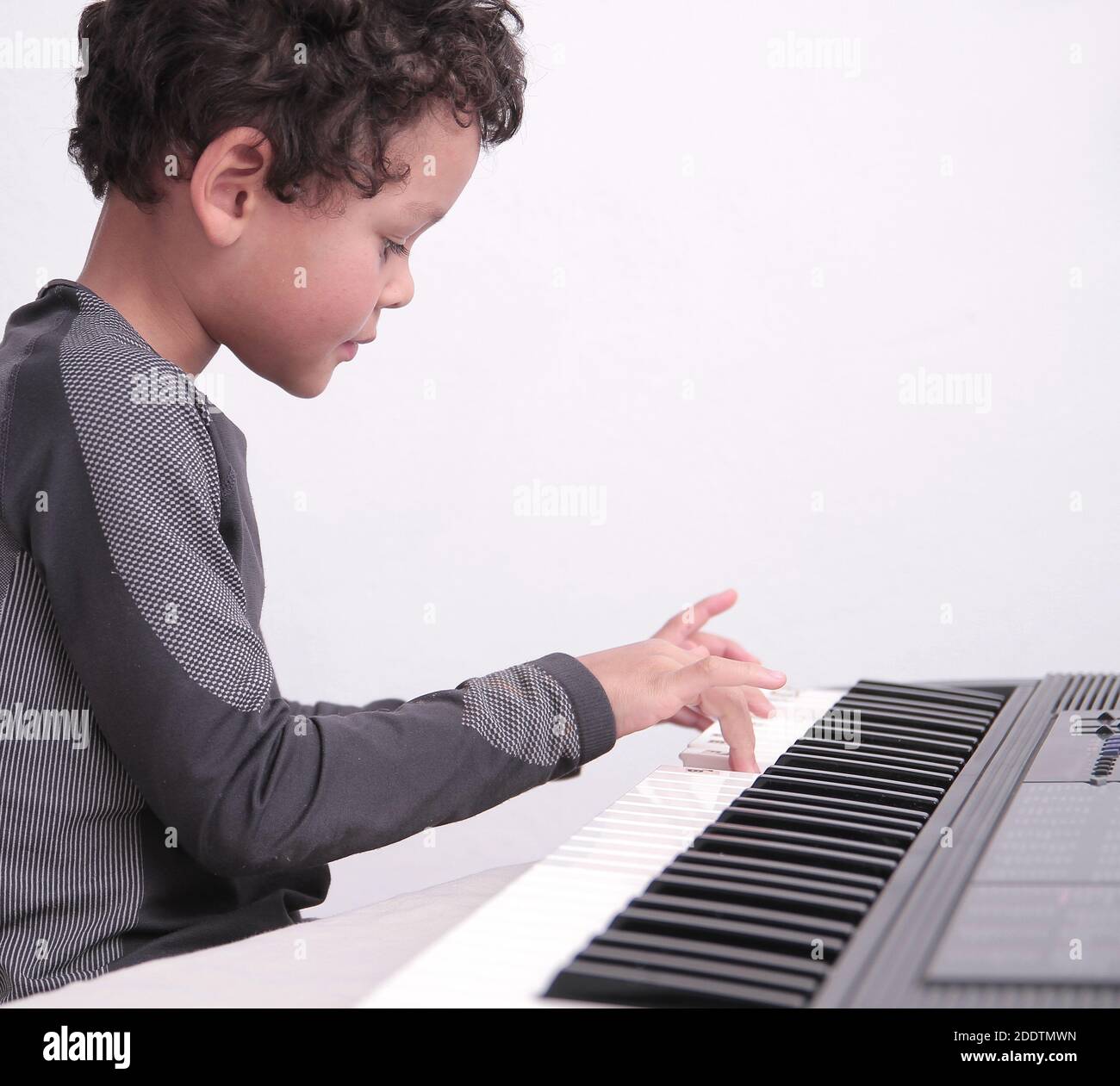 boy playing the piano keyboard on white background stock photo Stock ...