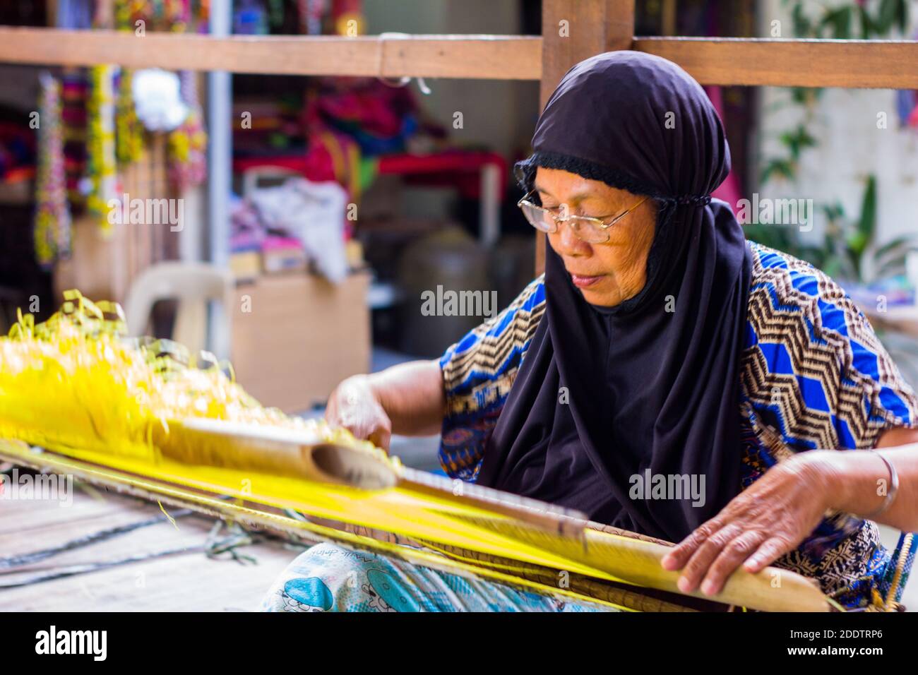 A Yakan elder doing traditional weaving at the Yakan Weaving Center in ...