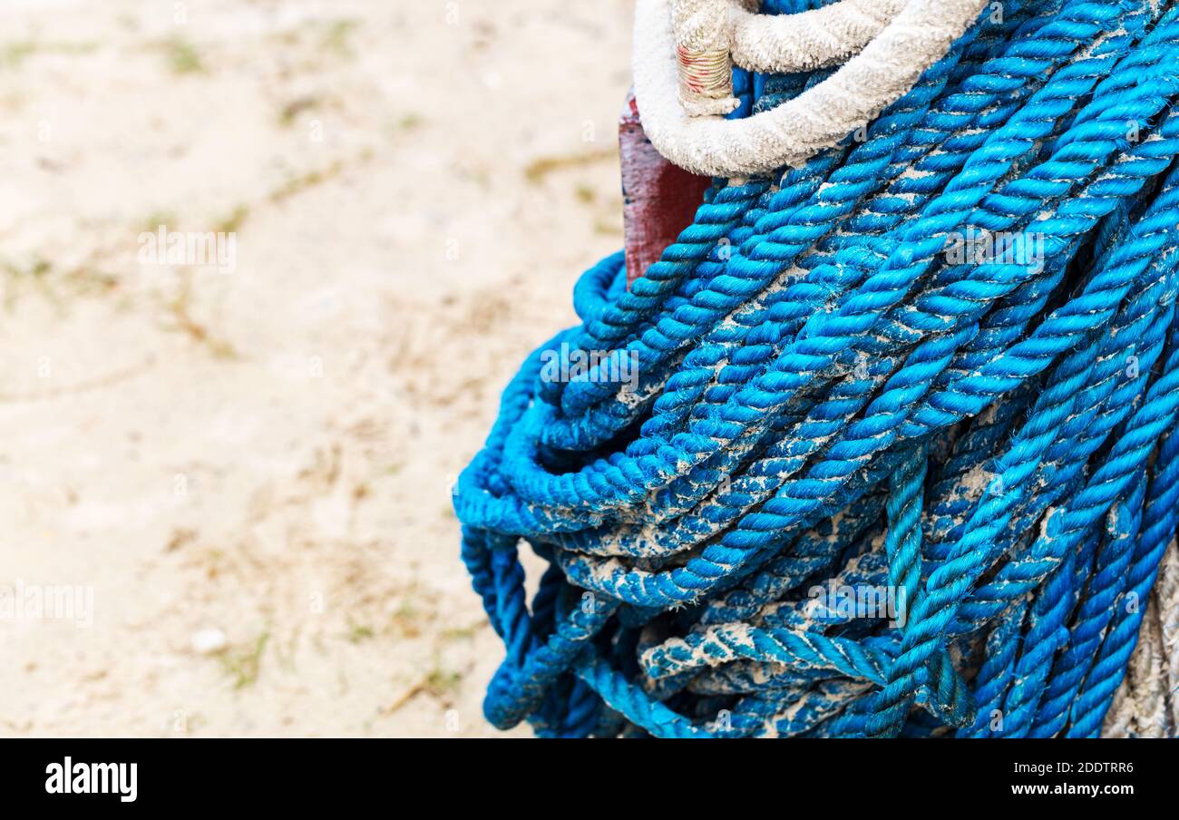 A closeup shot of coiled rope and sand Stock Photo - Alamy