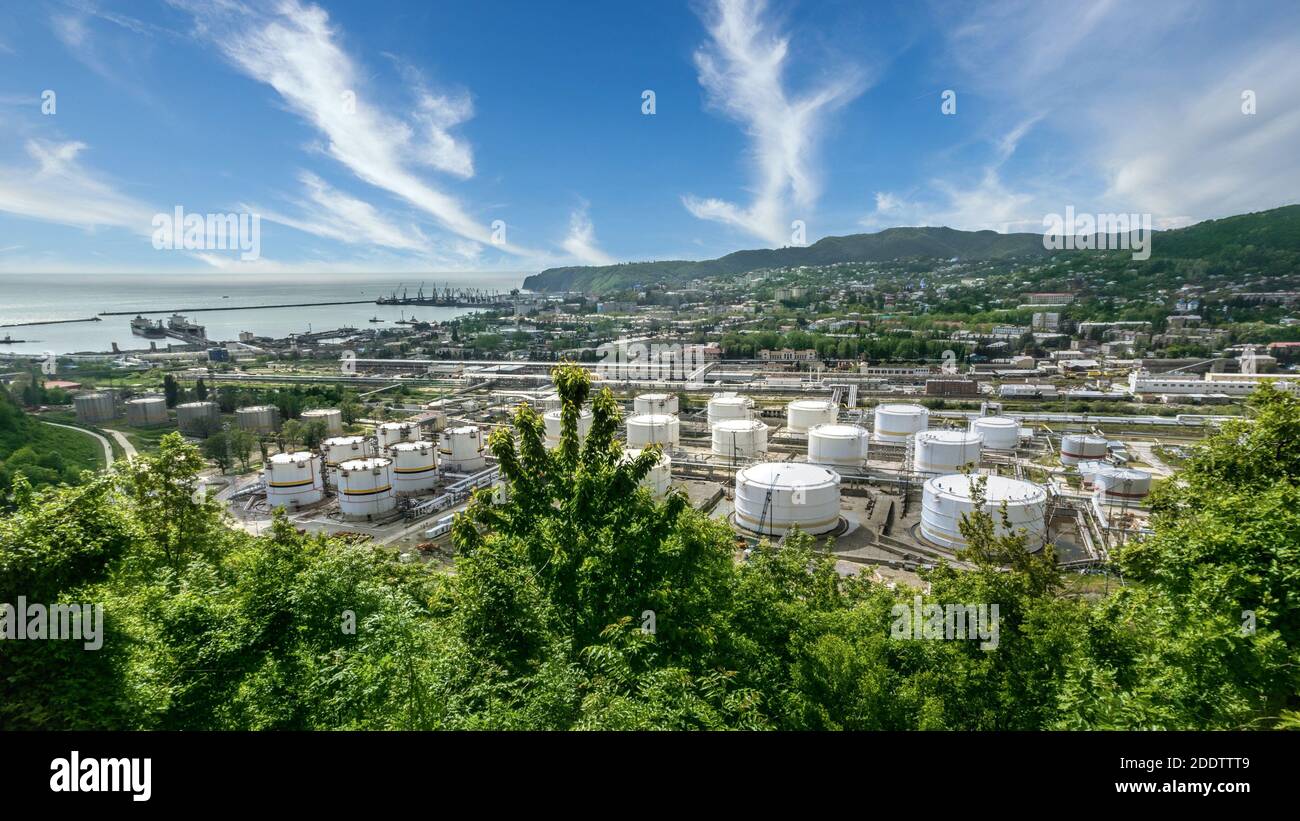Oil storage area with white tanks on sea coast Stock Photo - Alamy