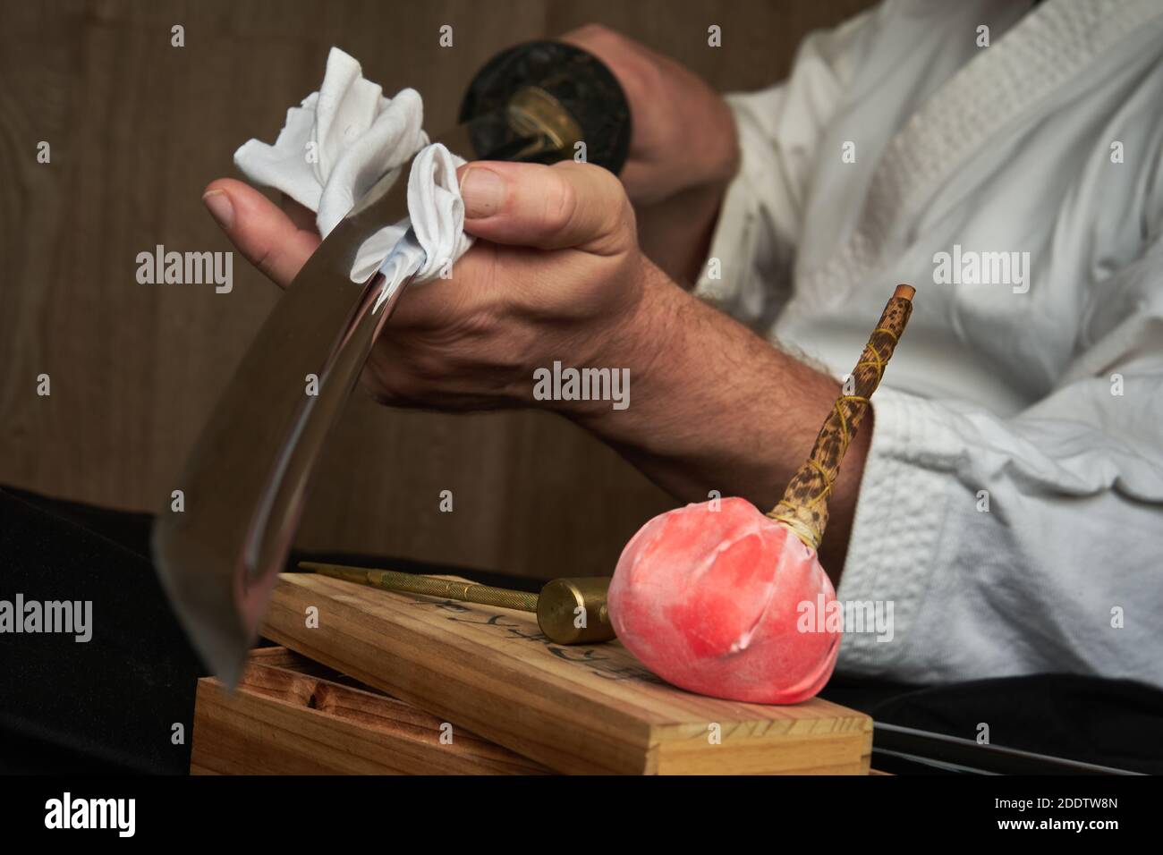 Man cleans blade of traditional Japanese katana sword Stock Photo - Alamy
