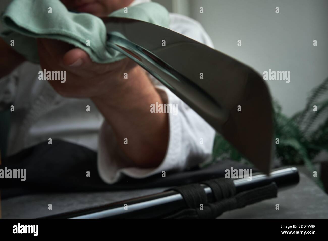 Man cleans blade of traditional Japanese katana sword Stock Photo - Alamy