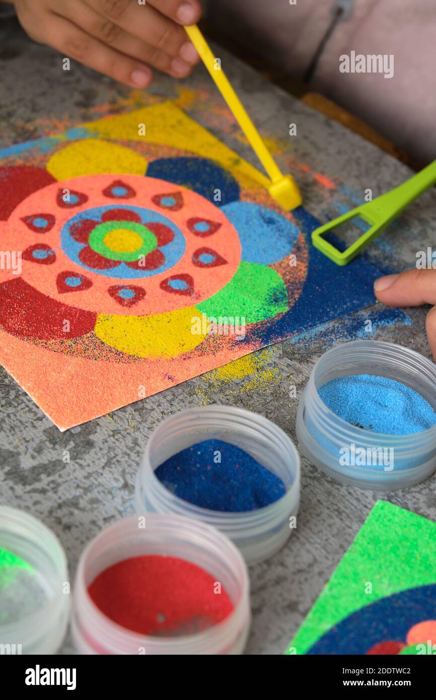 a mandala made of colored sand, the mom with the girls Stock Photo - Alamy