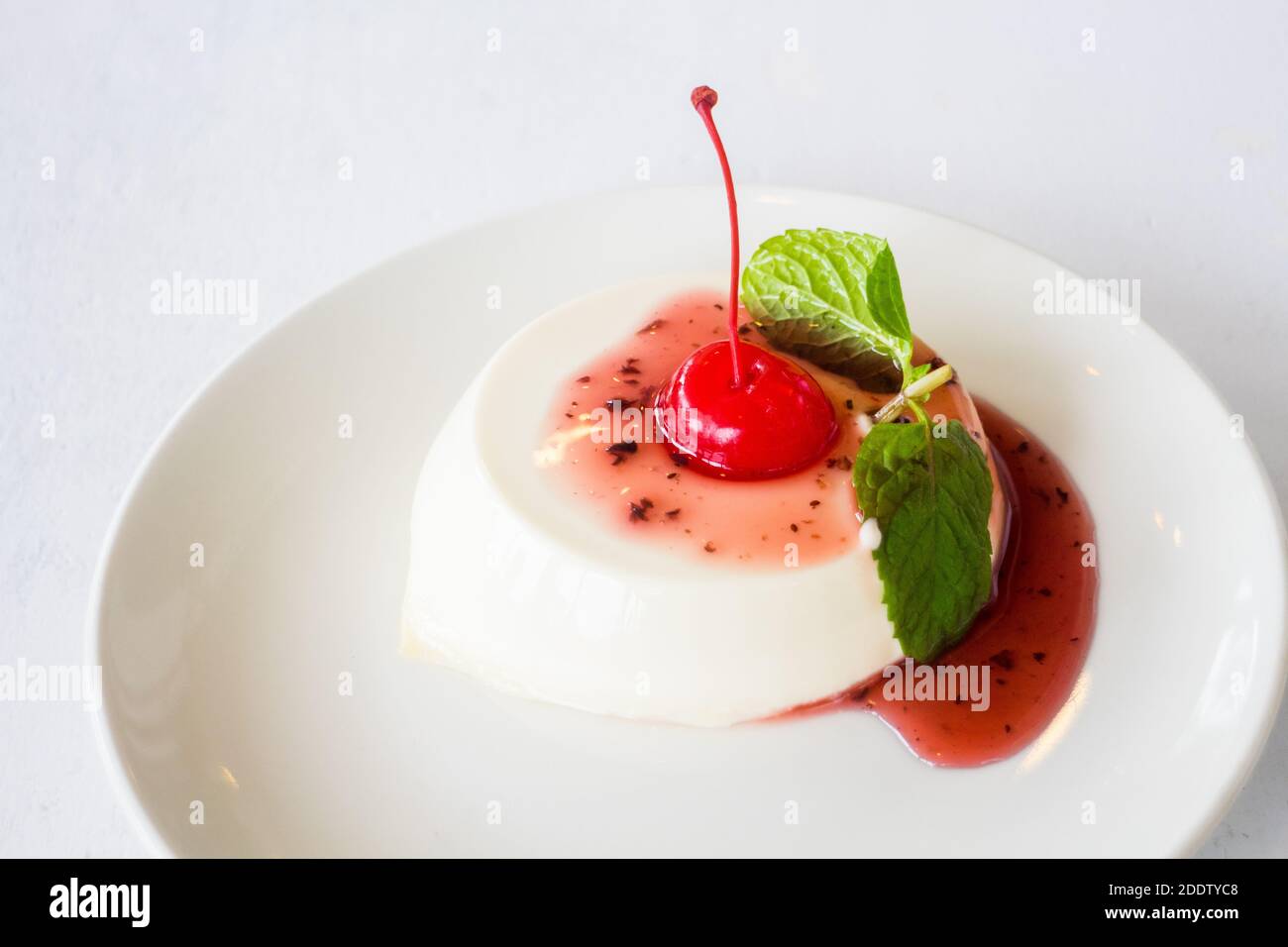 Panna cotta dessert topped with cherry at a restaurant in Baguio City ...
