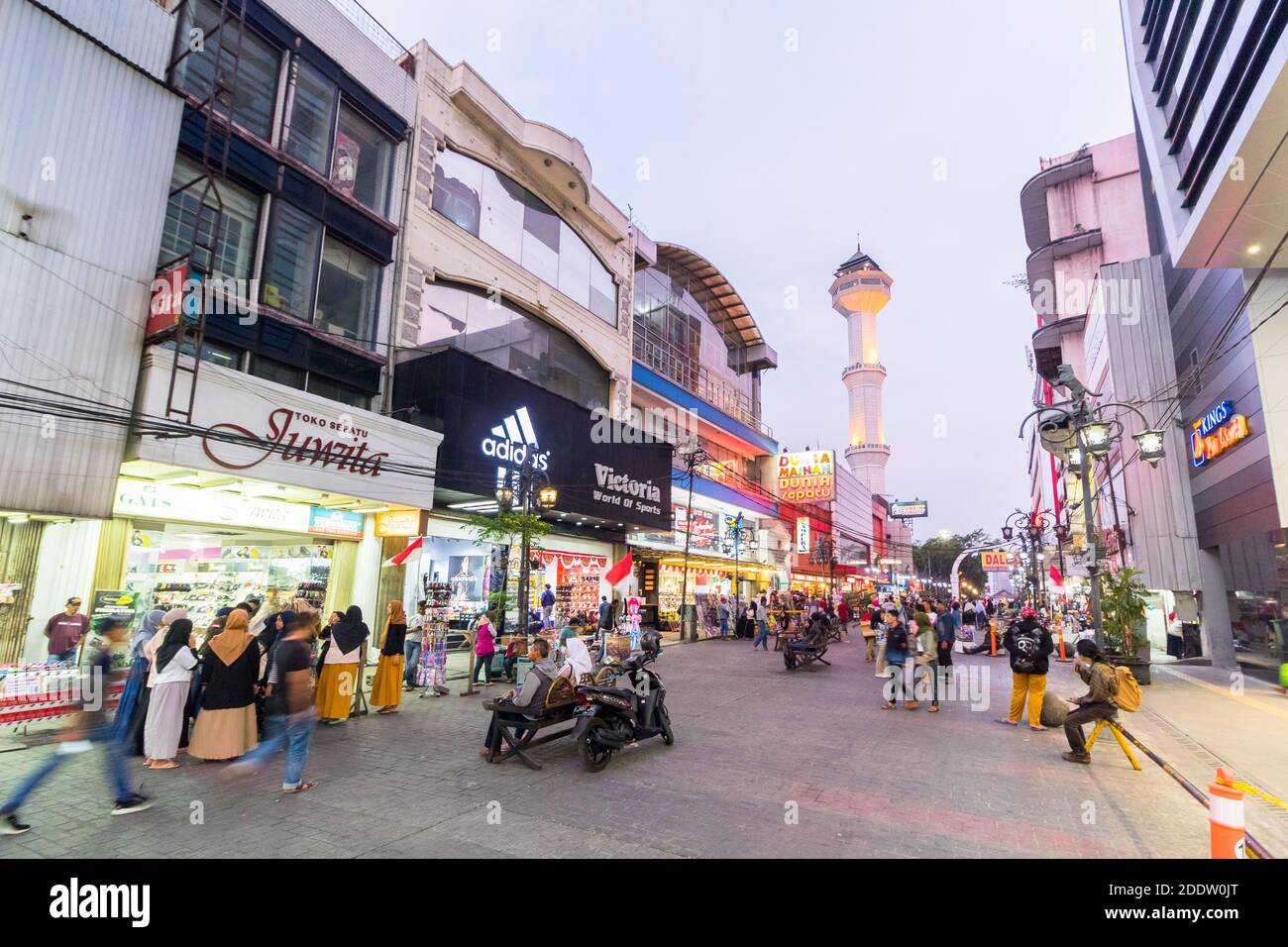 A busy Jalan Delam Kaum at night with one of the grand mosque's spire ...