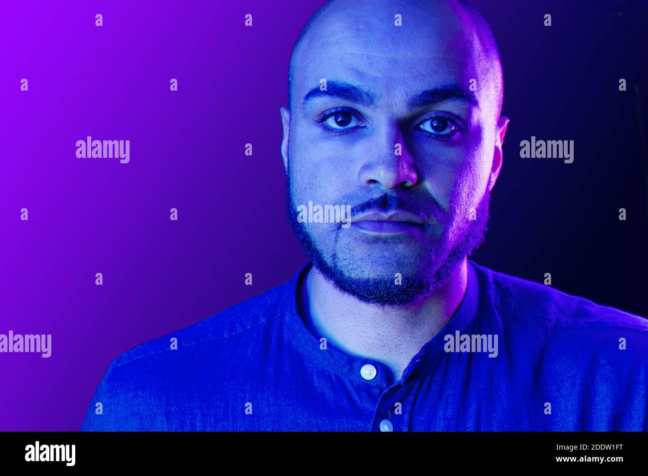 Serious thoughtful black guy portrait in neon light Stock Photo - Alamy