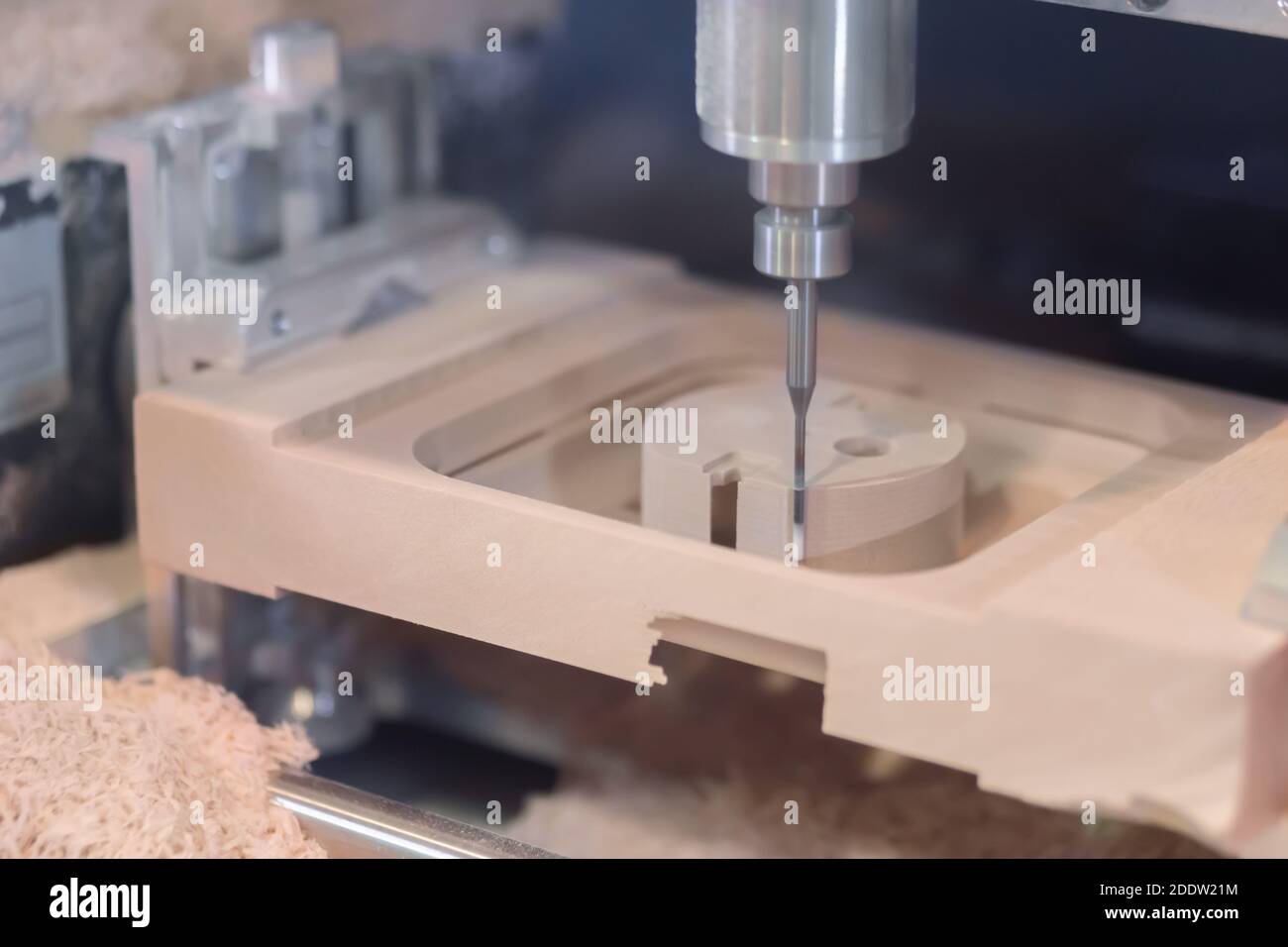 Milling machine cutting wooden workpiece from wood pulp at technology ...