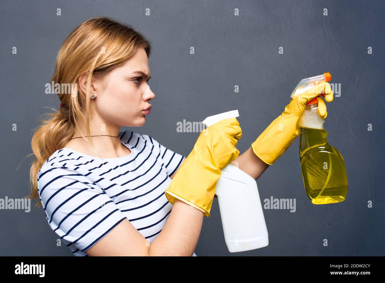 Emotional cleaning lady with detergent in hands of home care service ...
